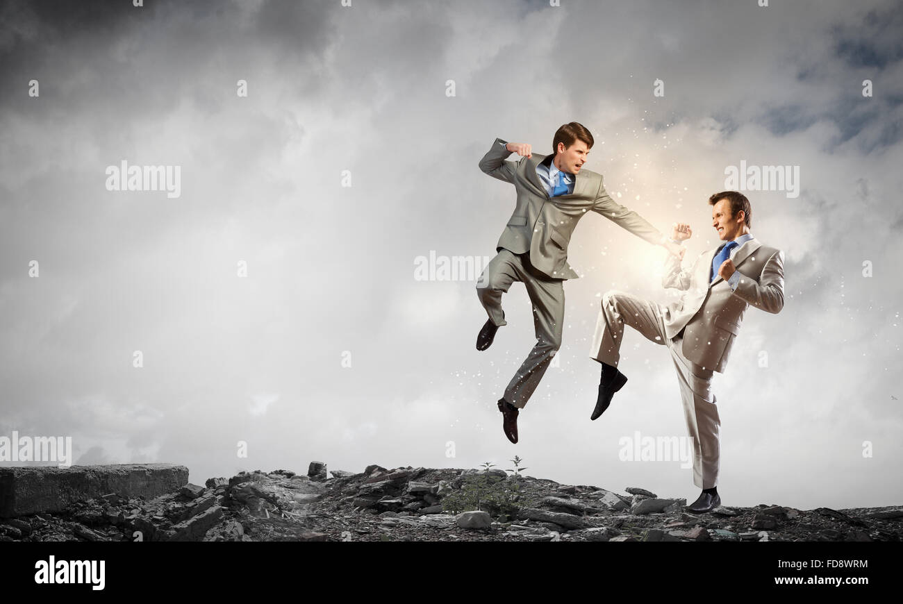 Two businesspeople in anger fighting with each other Stock Photo - Alamy