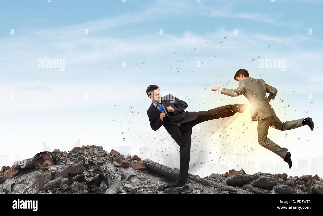 Two businesspeople in anger fighting with each other Stock Photo - Alamy