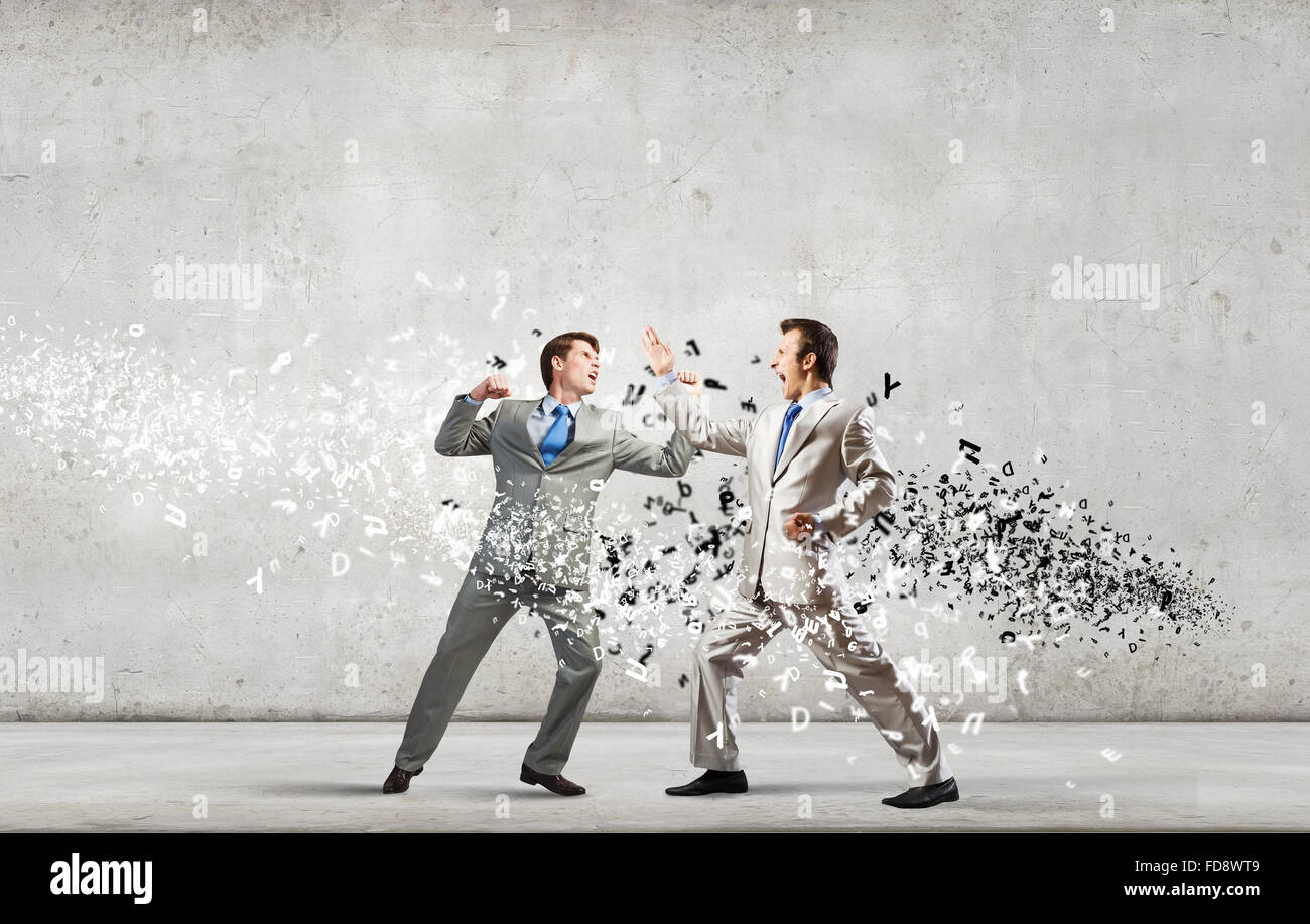 Two businesspeople in anger fighting with each other Stock Photo - Alamy