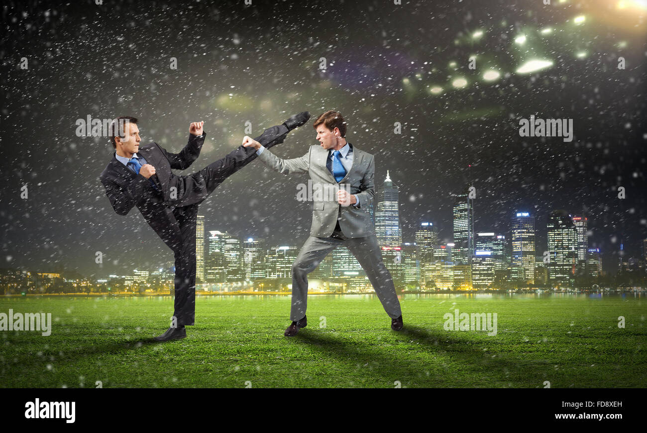 Two businesspeople in anger fighting with each other Stock Photo - Alamy