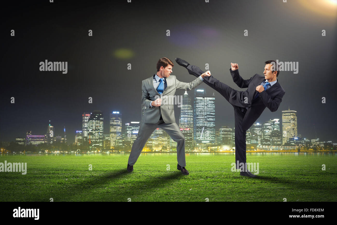 Two businesspeople in anger fighting with each other Stock Photo - Alamy