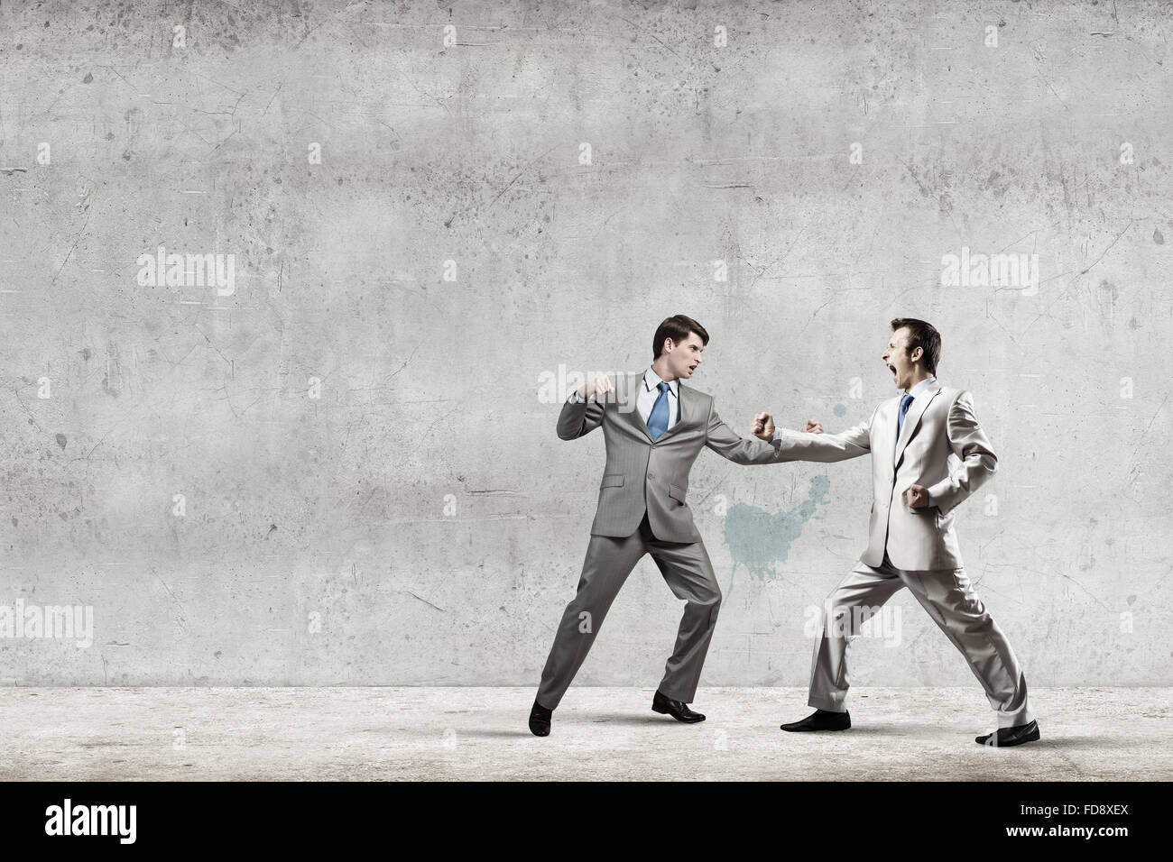Two businesspeople in anger fighting with each other Stock Photo - Alamy