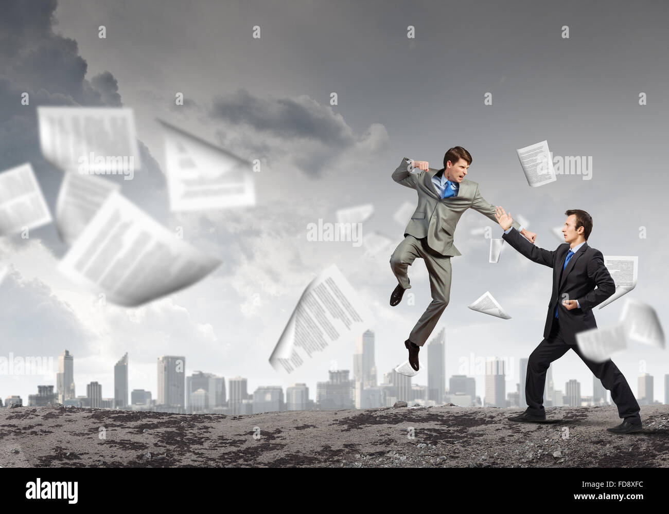 Two businesspeople in anger fighting with each other Stock Photo - Alamy