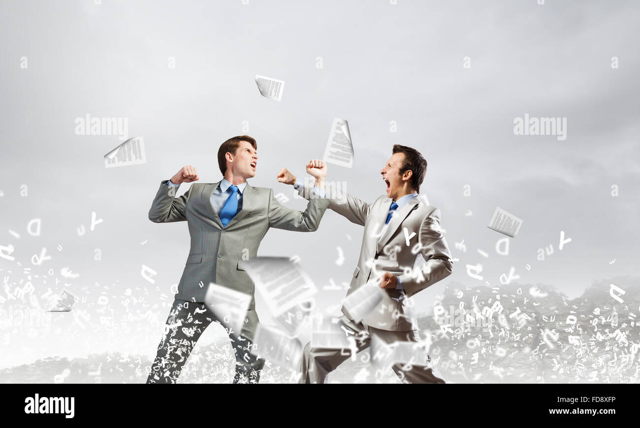 Two businesspeople in anger fighting with each other Stock Photo - Alamy