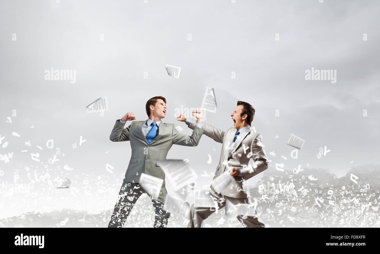 Two businesspeople in anger fighting with each other Stock Photo - Alamy