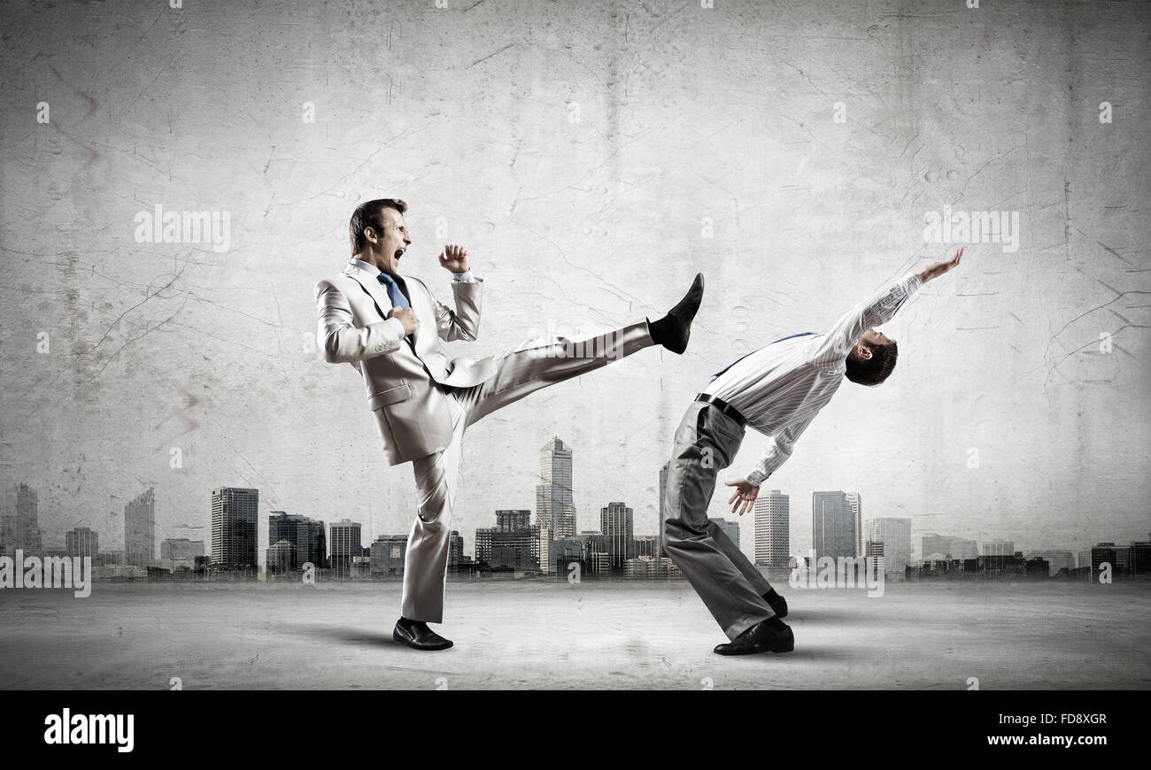 Two businesspeople in anger fighting with each other Stock Photo - Alamy