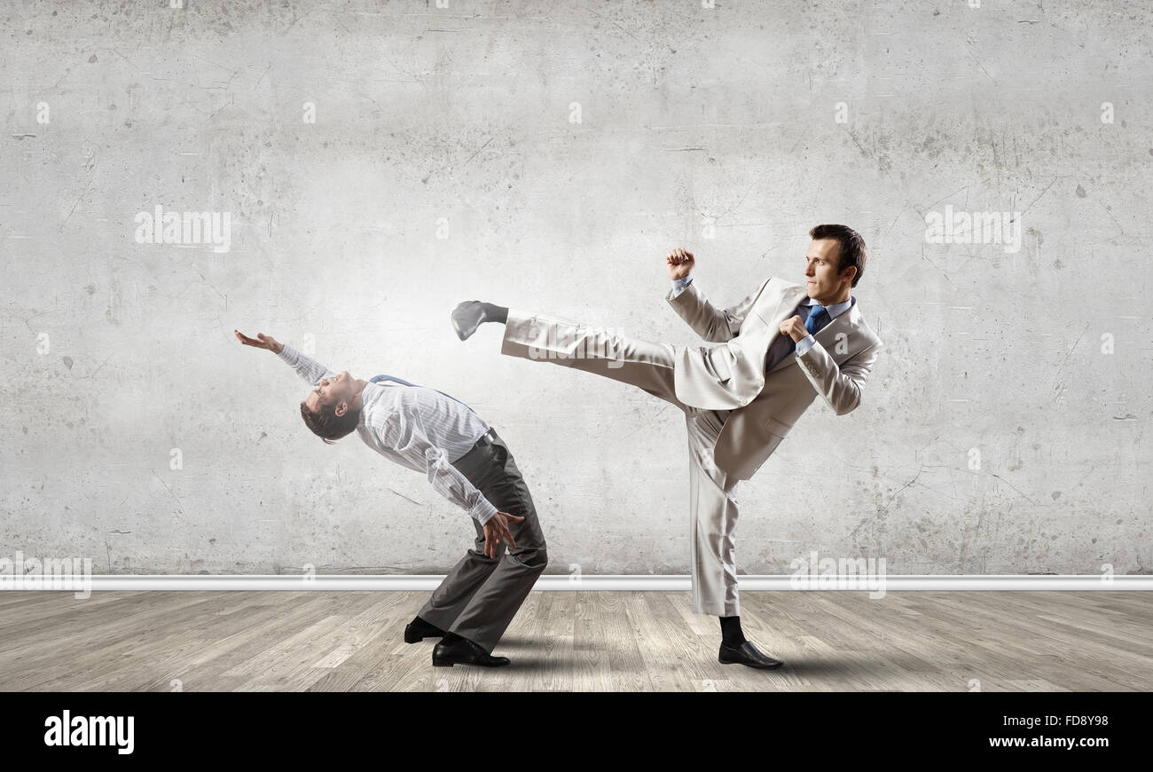 Two businesspeople in anger fighting with each other Stock Photo - Alamy