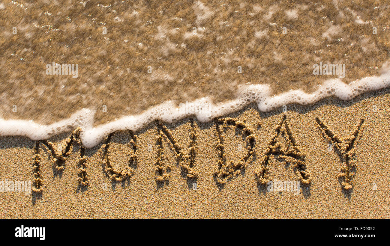 Inscription MONDAY on a gentle beach sand with the soft wave (days of ...