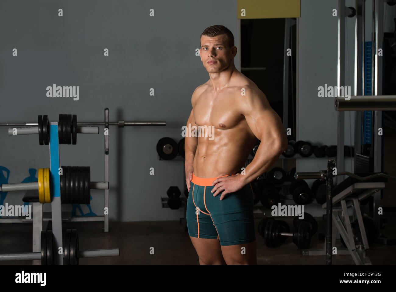 Portrait Of A Physically Fit Man Showing His Well Trained Body In Gym ...