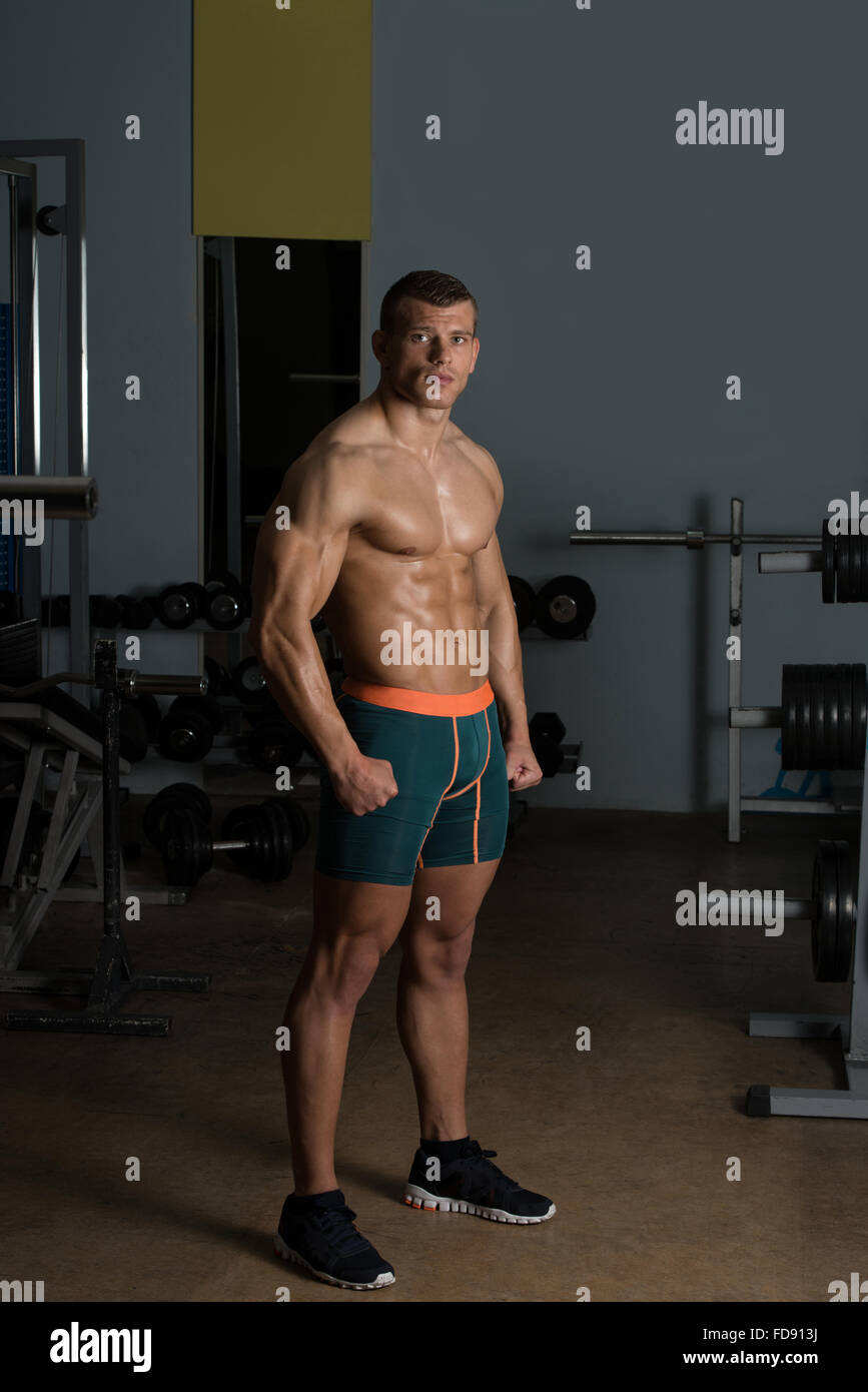 Portrait Of A Physically Fit Man Showing His Well Trained Body In Gym ...