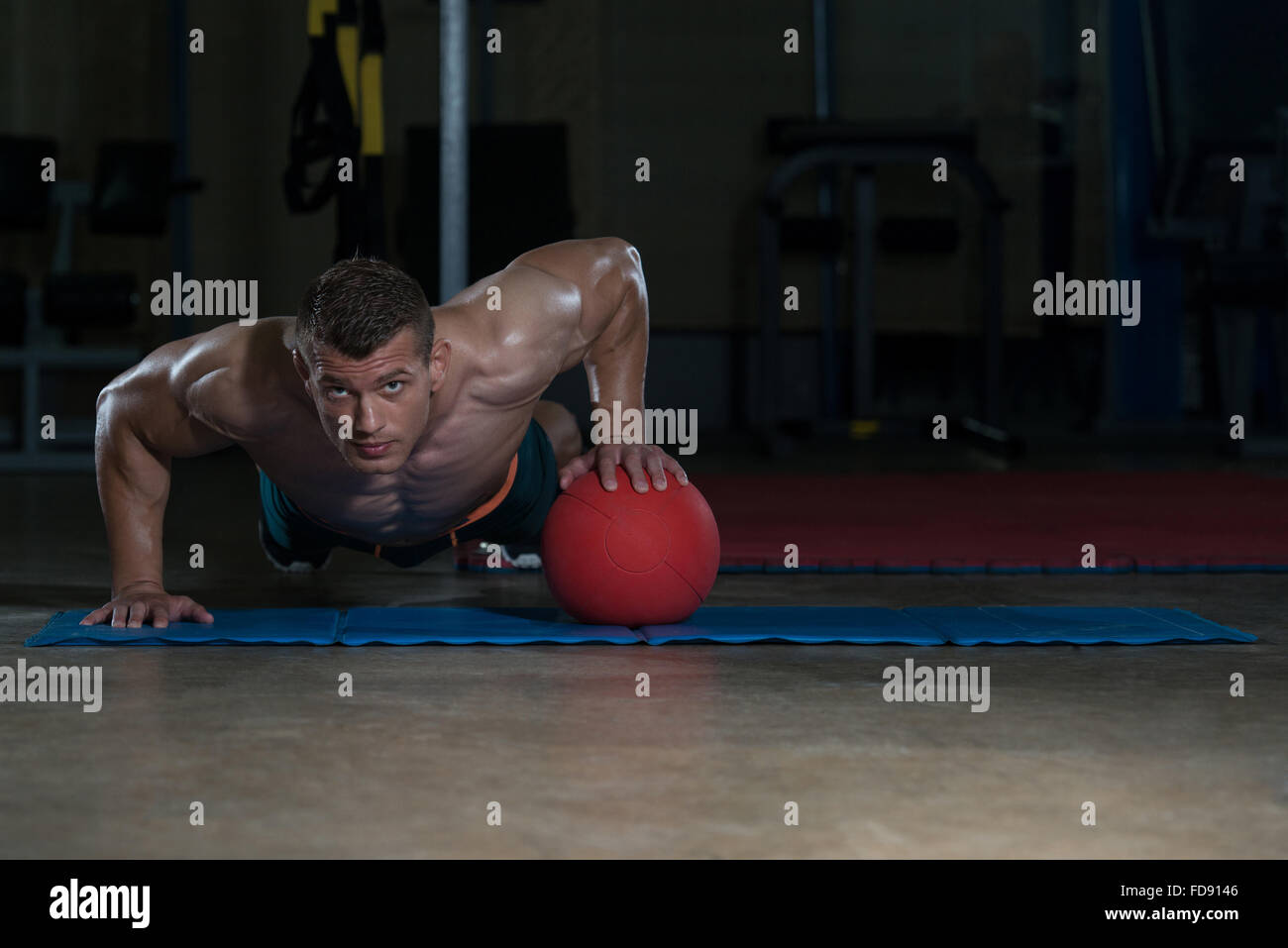 Young Adult Athlete Doing Push Ups On Medicine Ball As Part Of ...