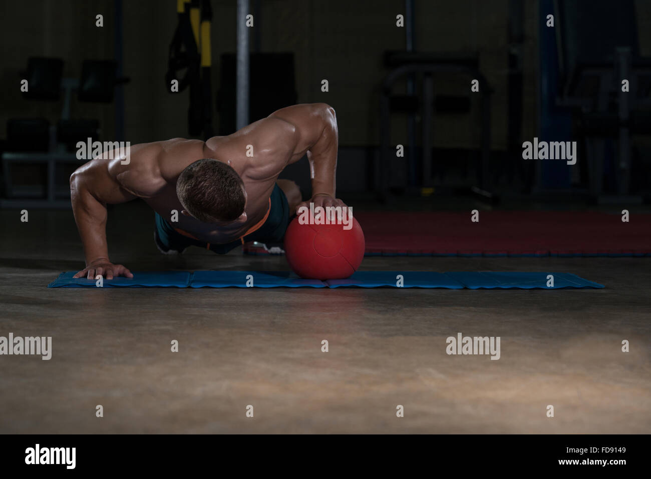 Young Adult Athlete Doing Push Ups On Medicine Ball As Part Of ...