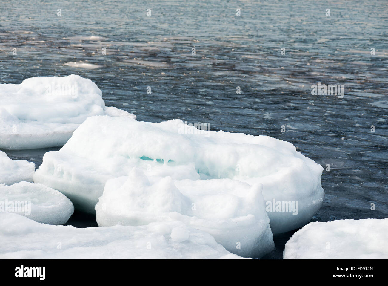 Natural sea ice blocks breaking up against shore and ice during ...