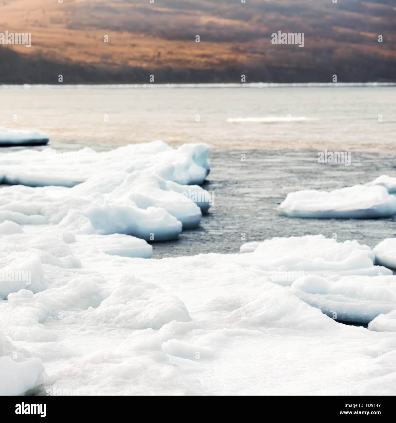 Natural sea ice blocks breaking up against shore and ice during ...