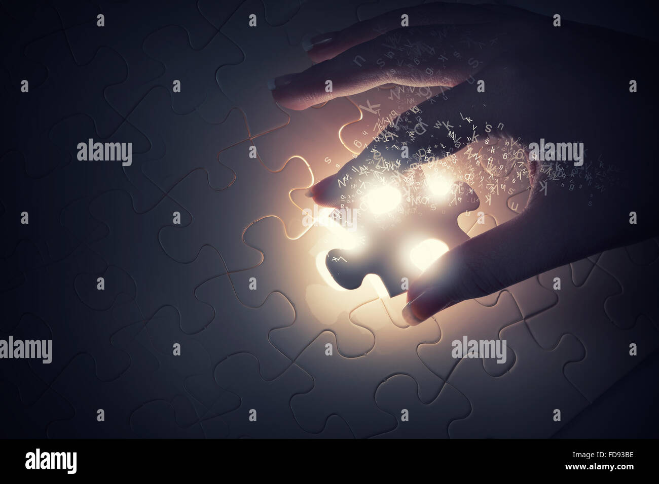 Close up of hands connecting puzzle element and making jigsaw complete ...