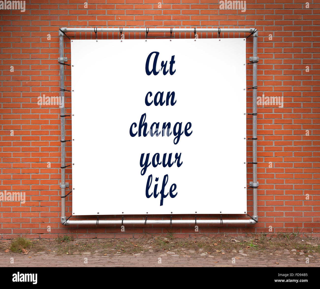 Large banner with inspirational quote on a brick wall - Art can change ...