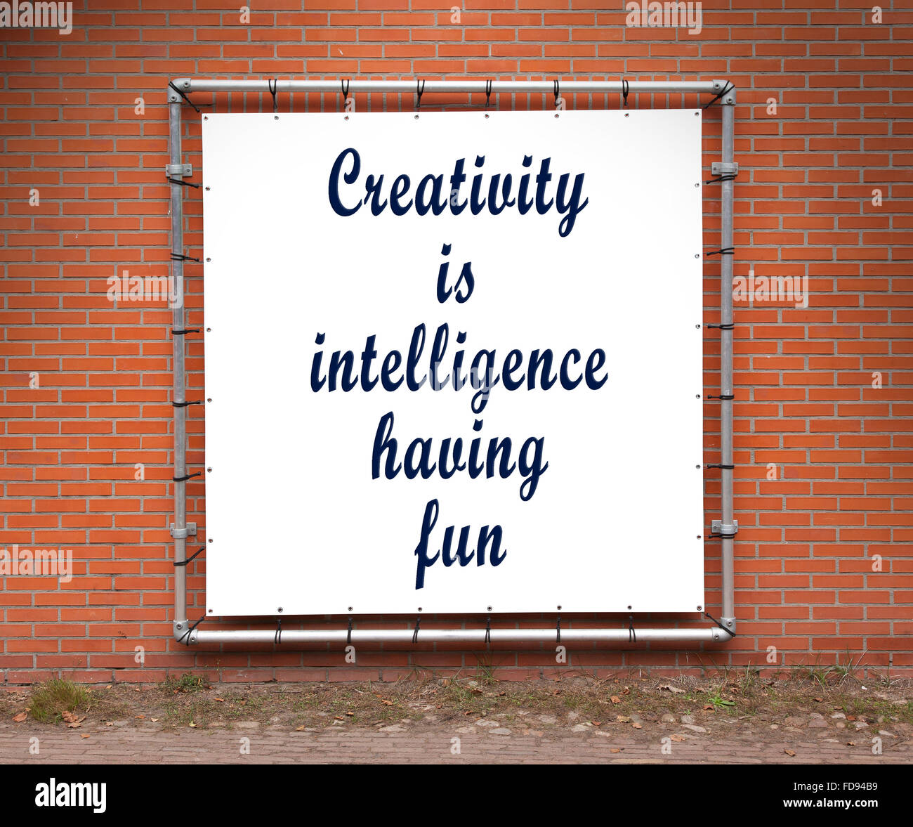 Large banner with inspirational quote on a brick wall - Creativity is ...