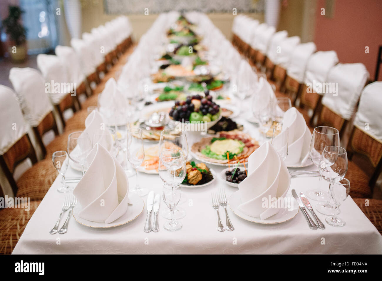 Banquet wedding table setting on evening reception awaiting guests ...