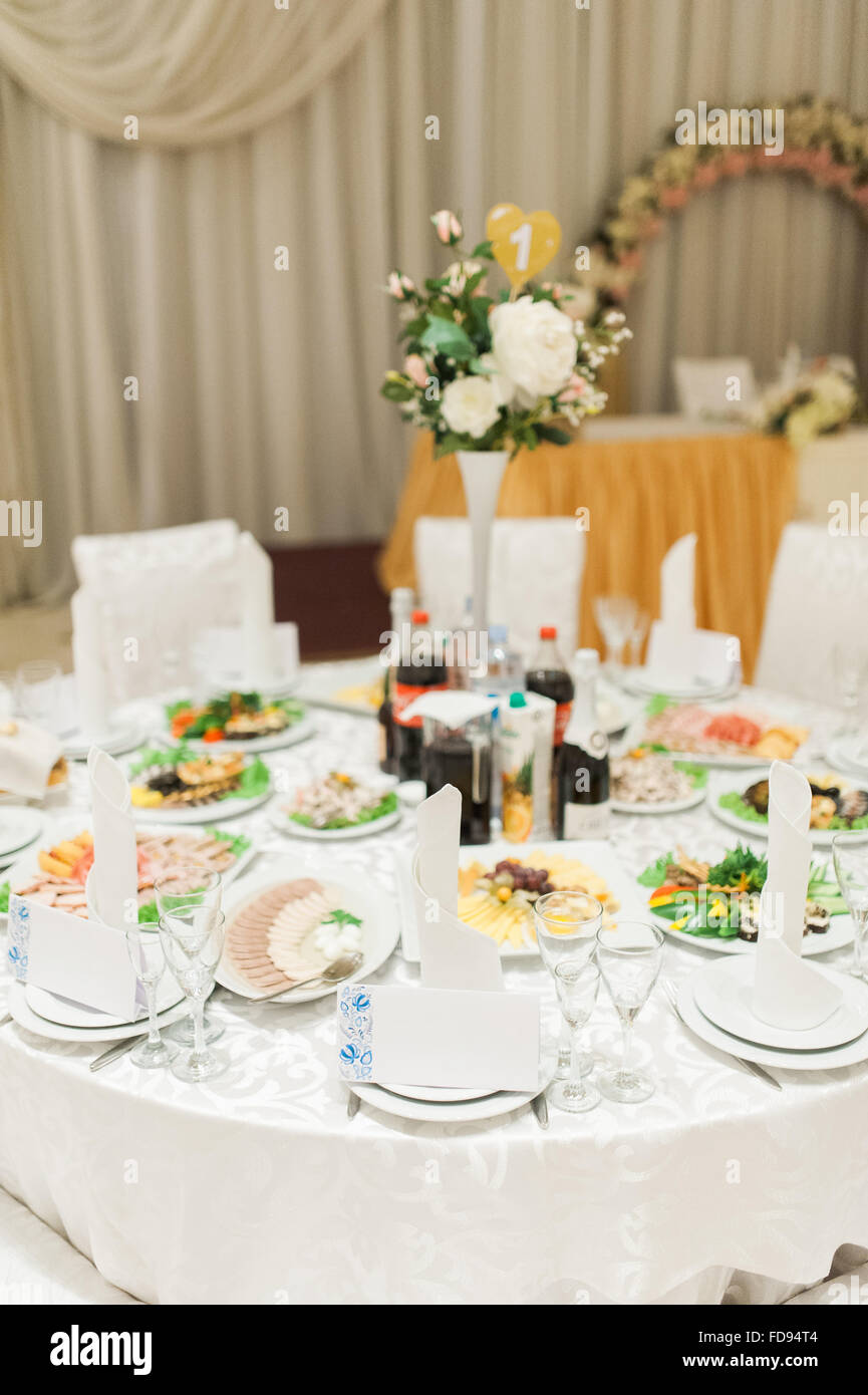 Banquet wedding table setting on evening reception awaiting guests ...