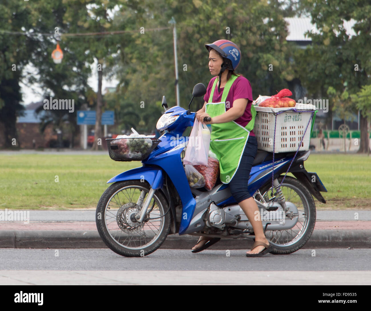 Asian woman with vegetable on scooter Stock Photo - Alamy
