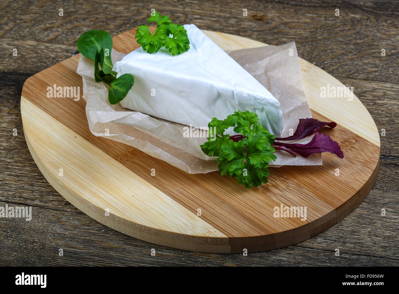 Soft brie cheese served parsley leaves on wooden background Stock Photo ...
