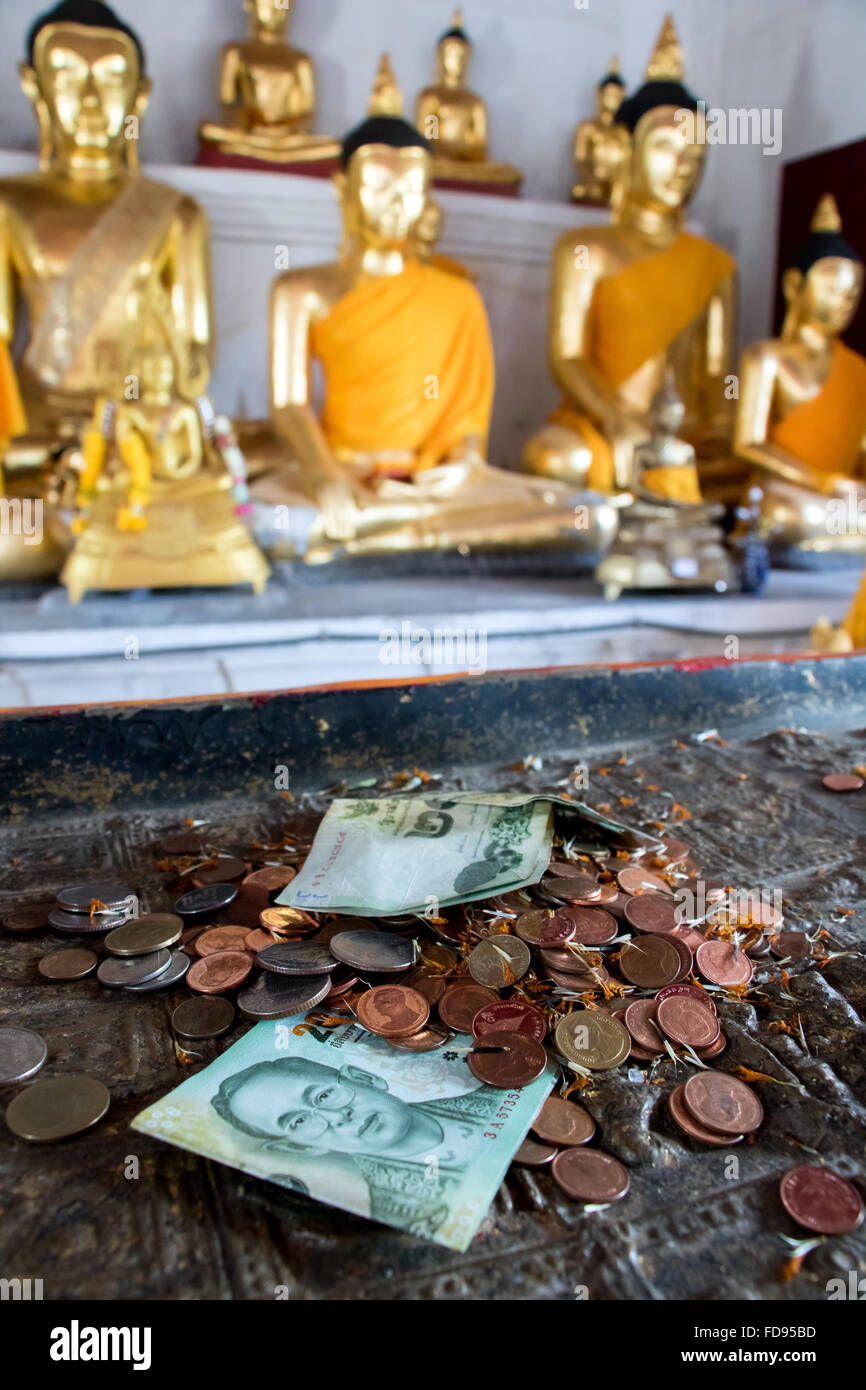 donated money under the statue of Buddha Stock Photo - Alamy