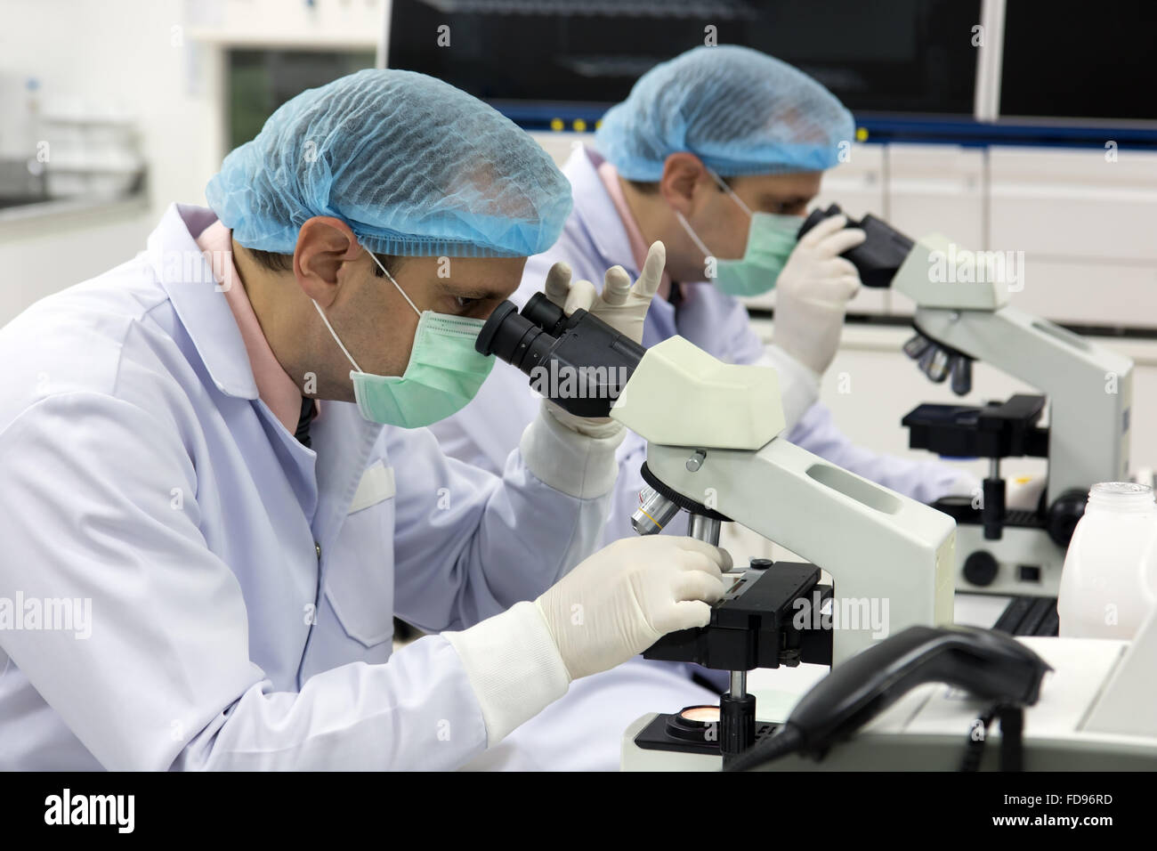 researchers working in a laboratory with microscope Stock Photo - Alamy