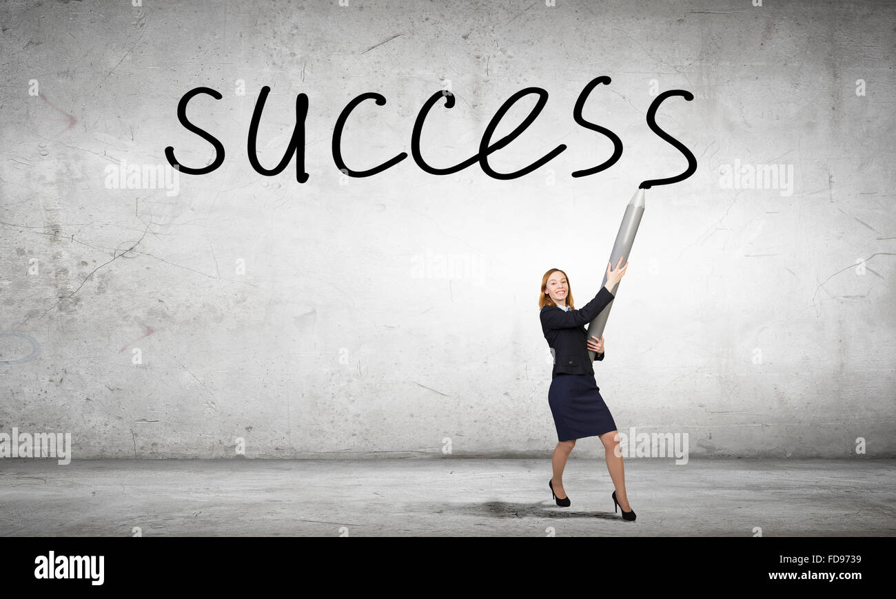 Businesswoman drawing word success with huge pencil Stock Photo - Alamy
