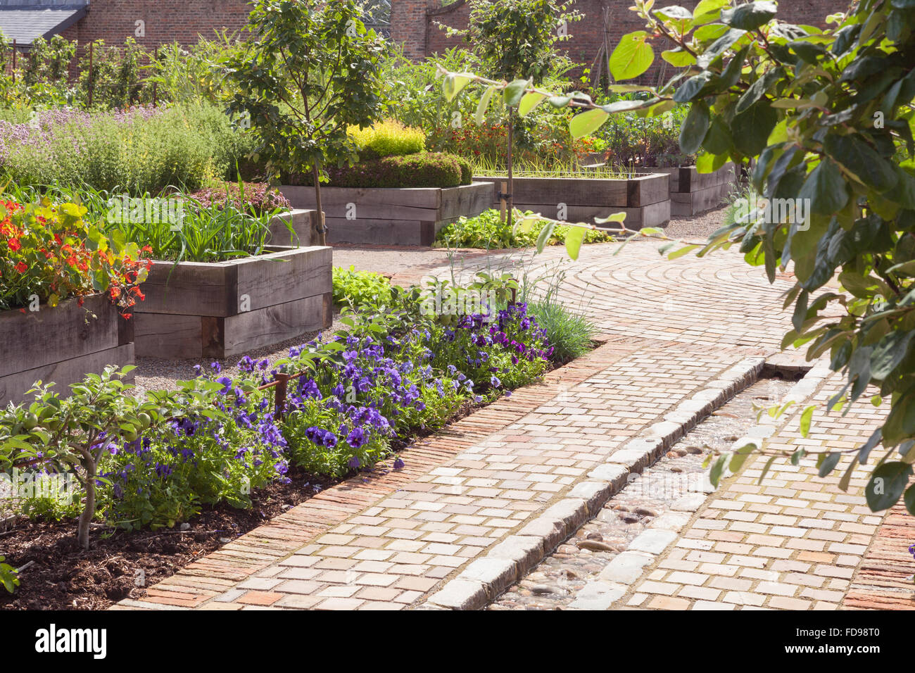 A shallow rill water feature and raised beds. The Kitchen Garden at ...