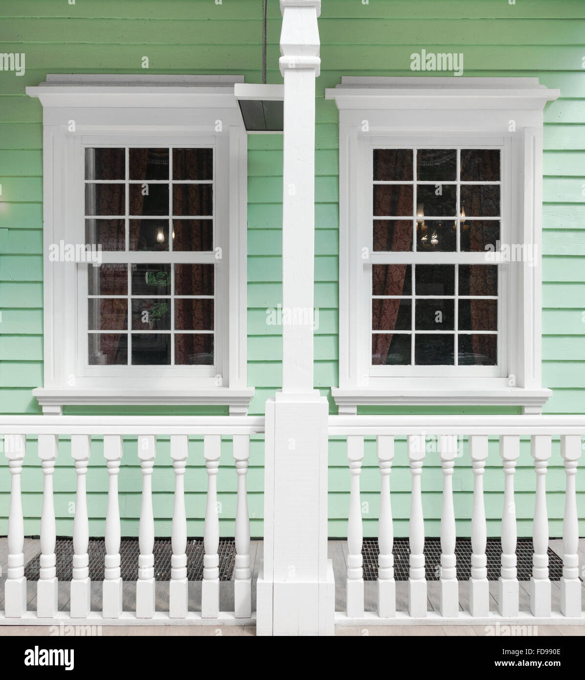 Detail of the facade of a saloon painted green with white windows Stock ...