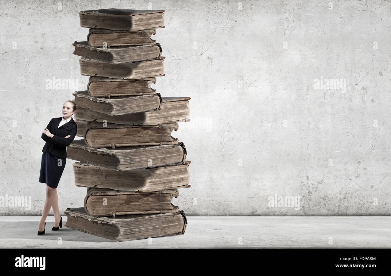 Young woman and huge pile of old books Stock Photo - Alamy