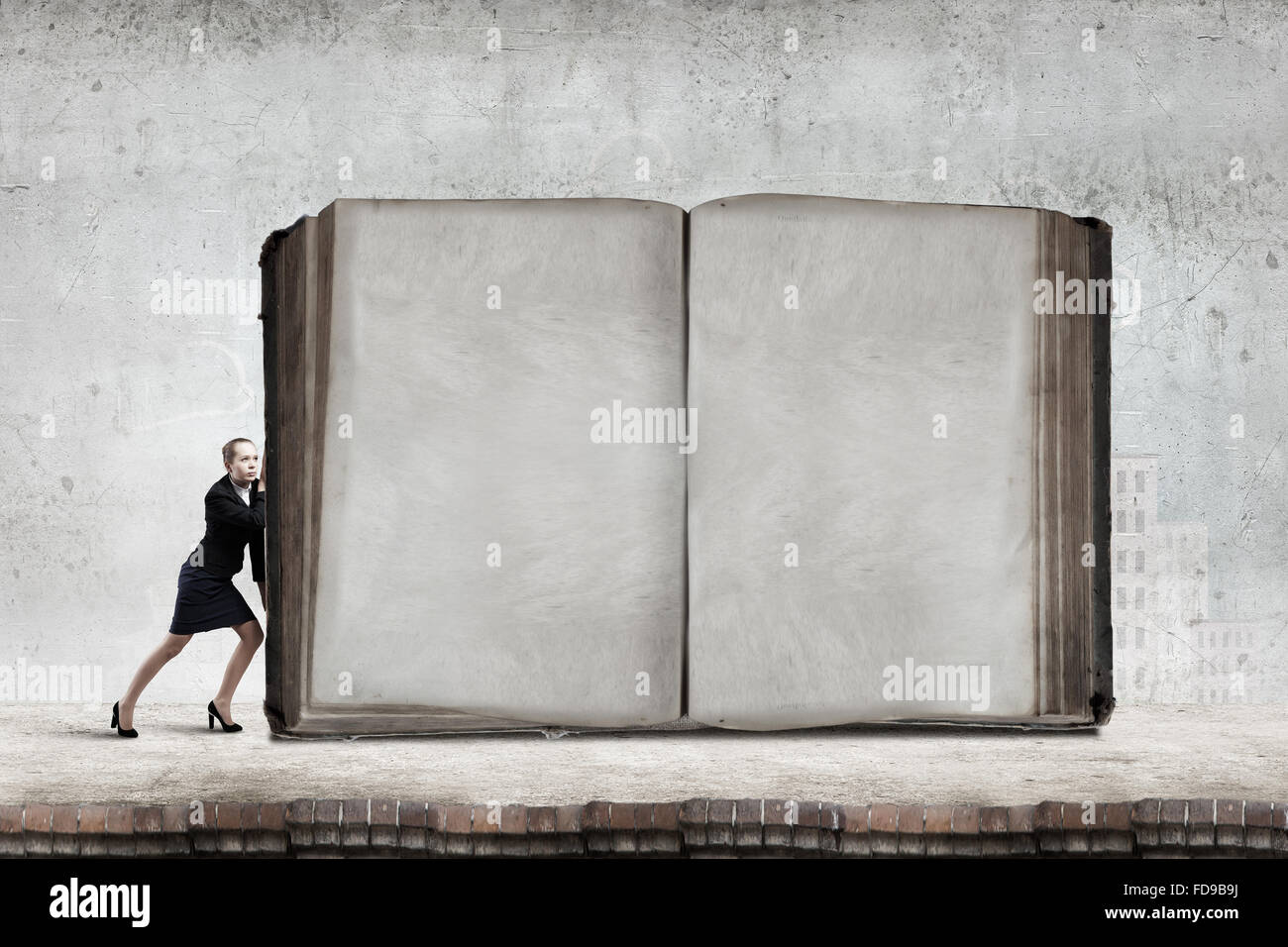Young woman making effort to push huge old book Stock Photo - Alamy