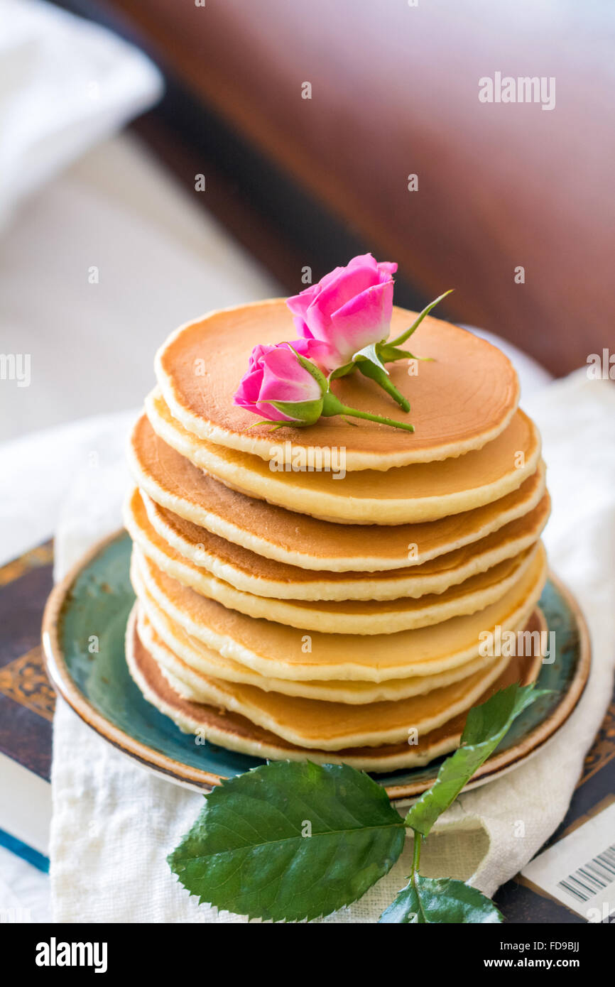 Stack of pancake and rose flowers served in bed Stock Photo - Alamy