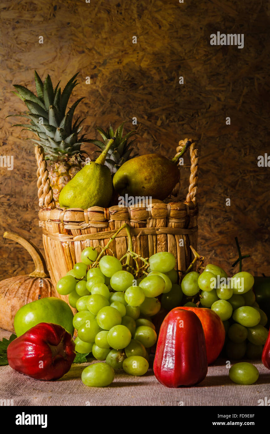Still life with fruits placed in a basket made of natural materials ...