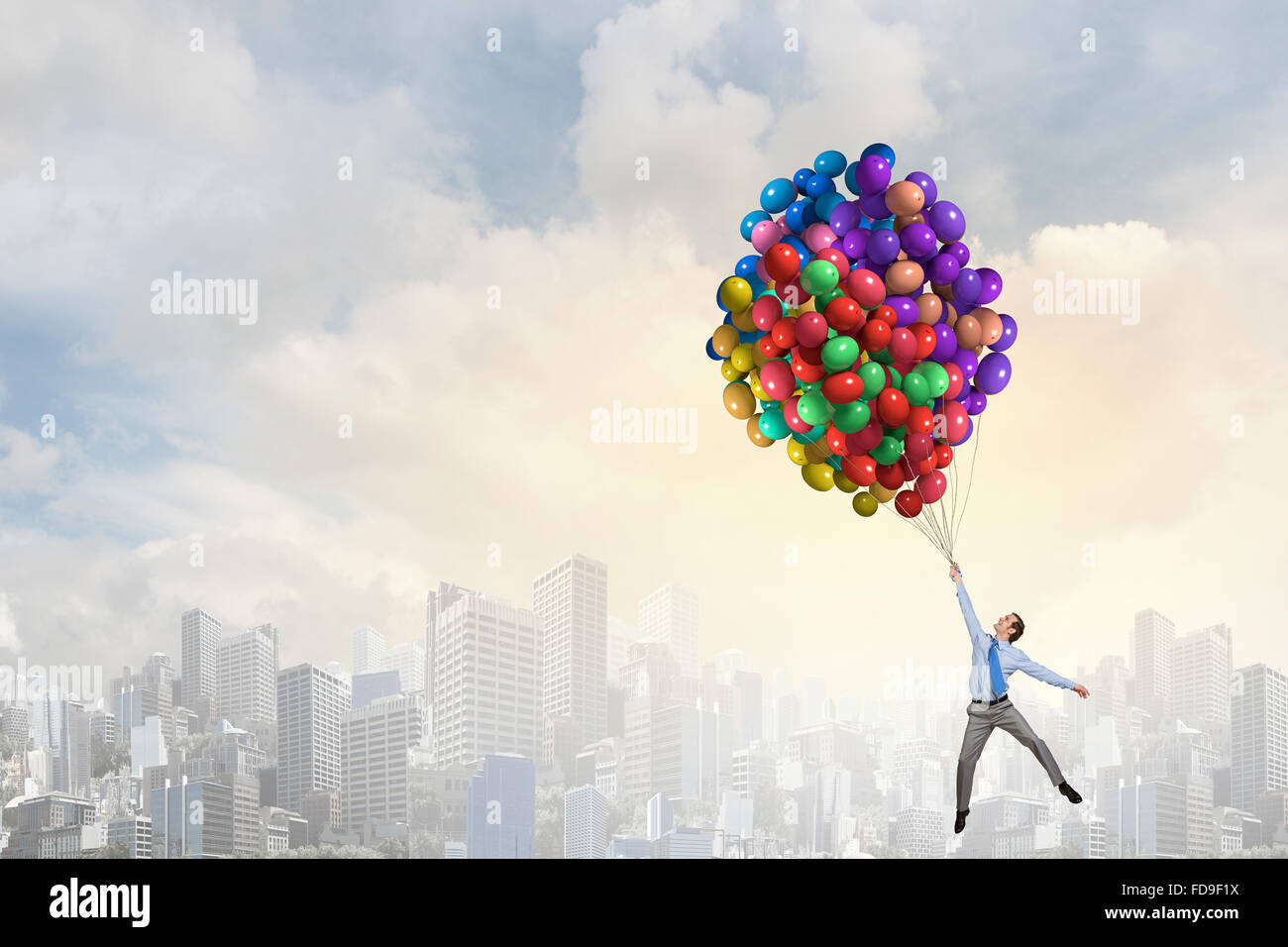 Young successful businessman flies on bunch of colorful balloons Stock ...
