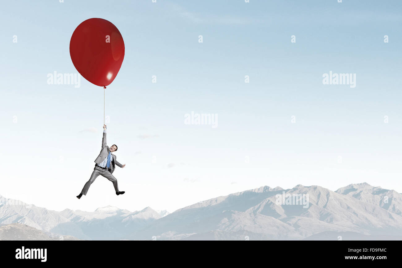 Young successful businessman flies on colorful balloon Stock Photo - Alamy