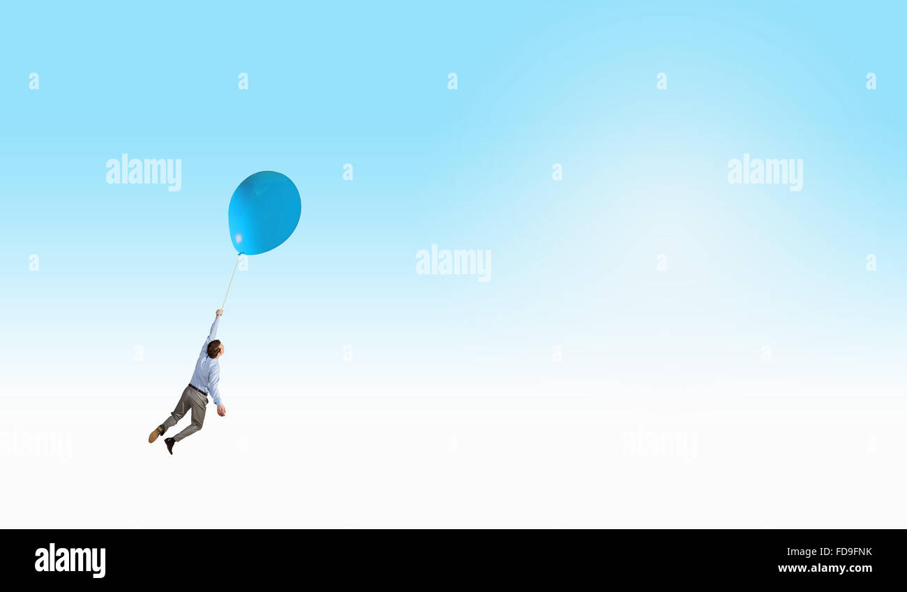 Young successful businessman flies on colorful balloon Stock Photo - Alamy