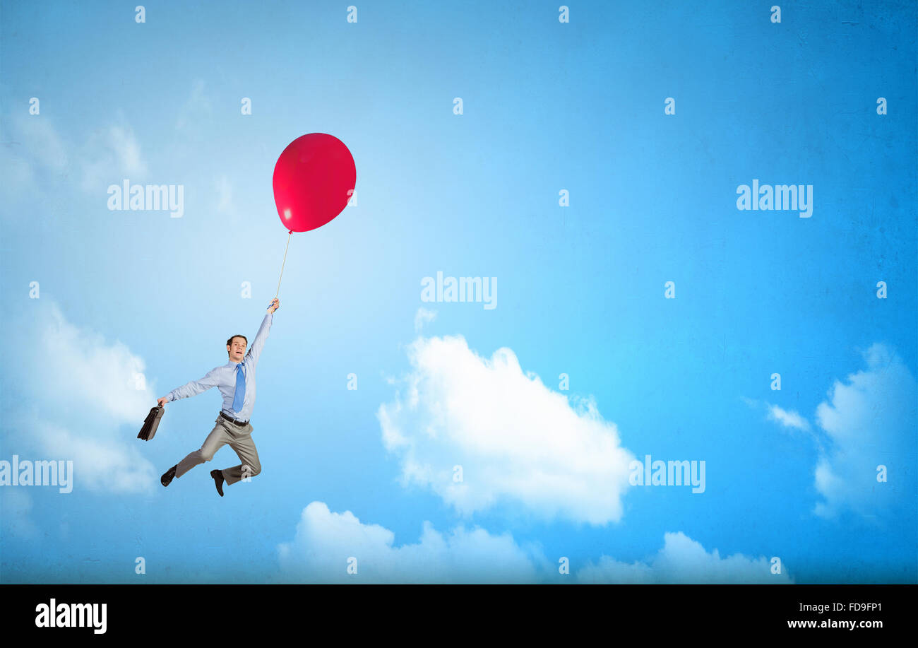 Young successful businessman flies on colorful balloon Stock Photo - Alamy