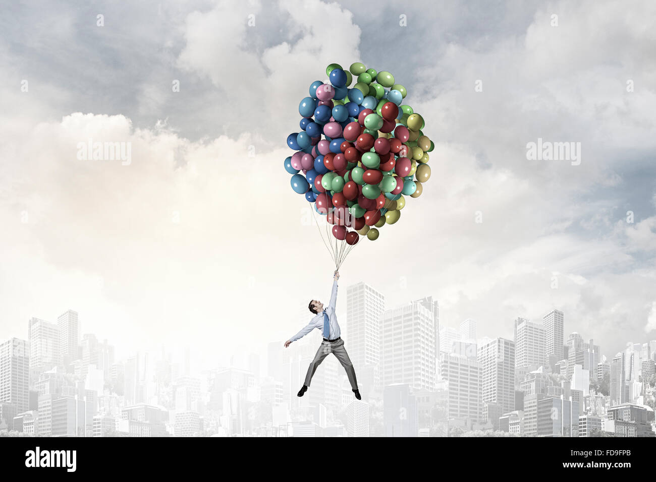 Young successful businessman flies on bunch of colorful balloons Stock ...