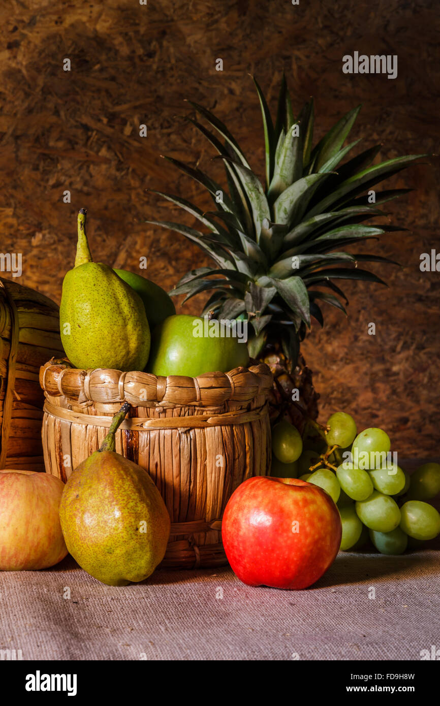 Still life with fruits placed in a basket made of natural materials ...
