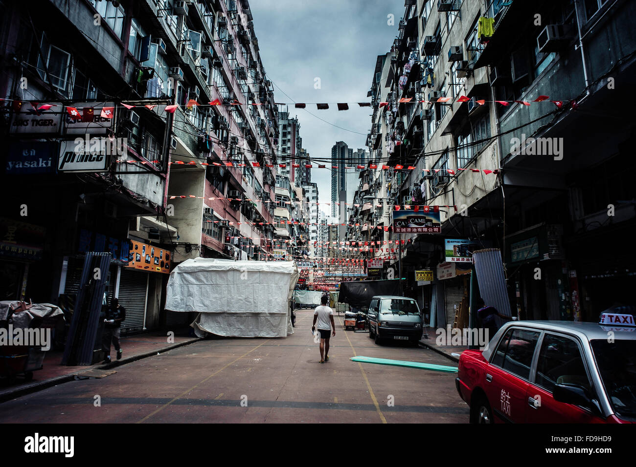 Man Walking On Street Between Buildings Stock Photo - Alamy