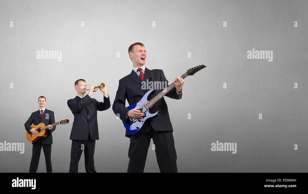 Young man in suit and people playing different music instruments Stock ...