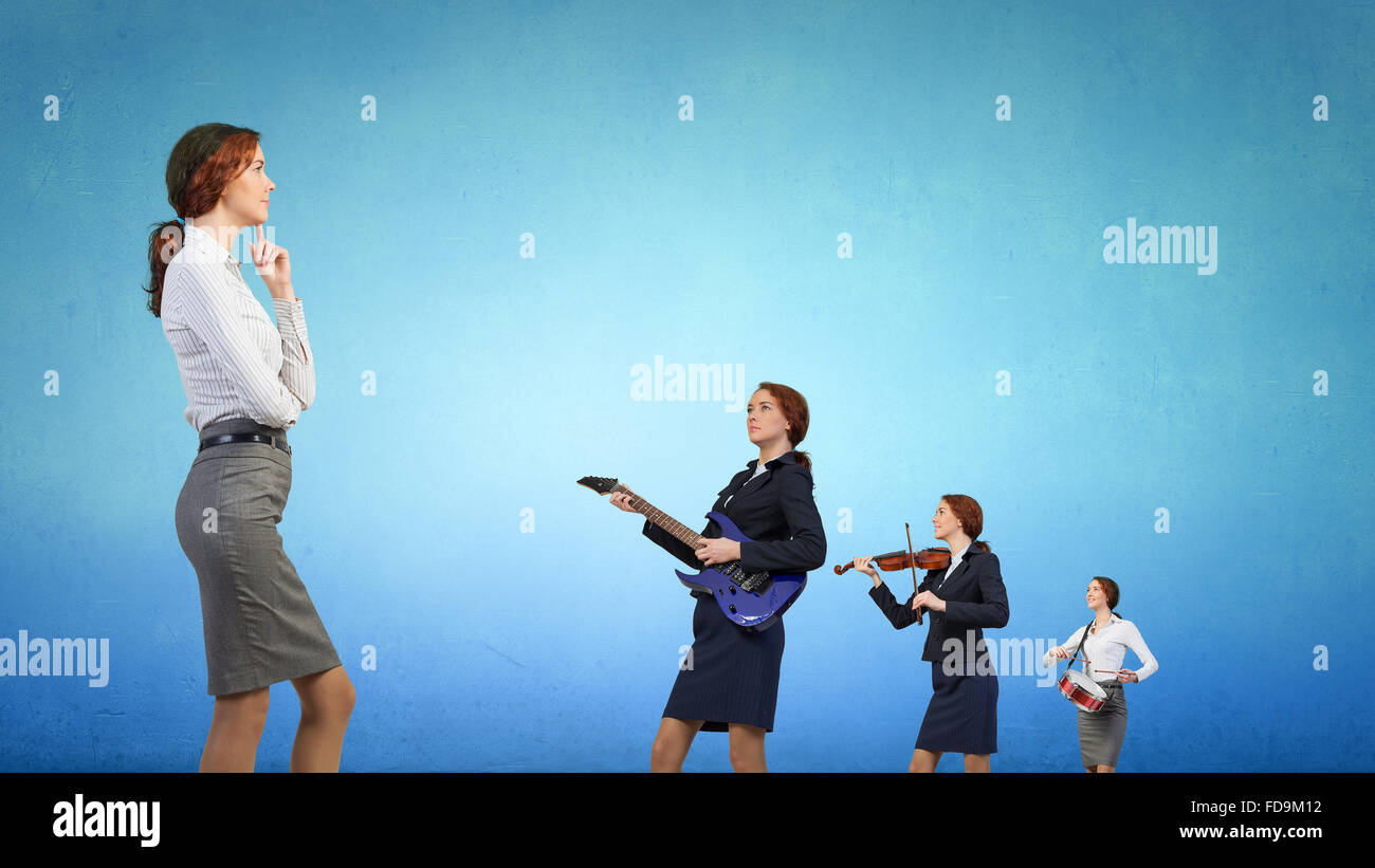 Young woman in suit playing different music instruments Stock Photo - Alamy