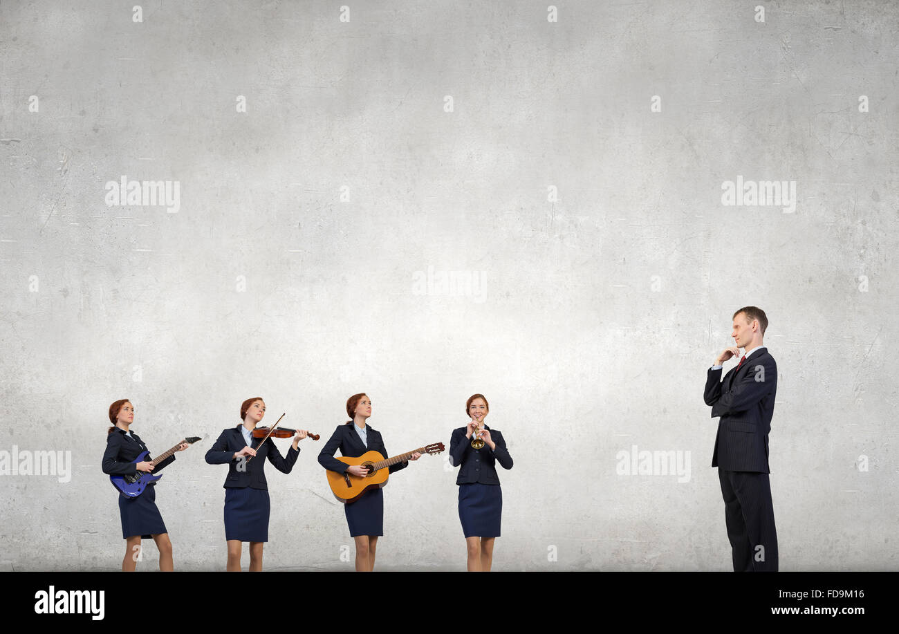 Young woman in suit playing different music instruments Stock Photo - Alamy