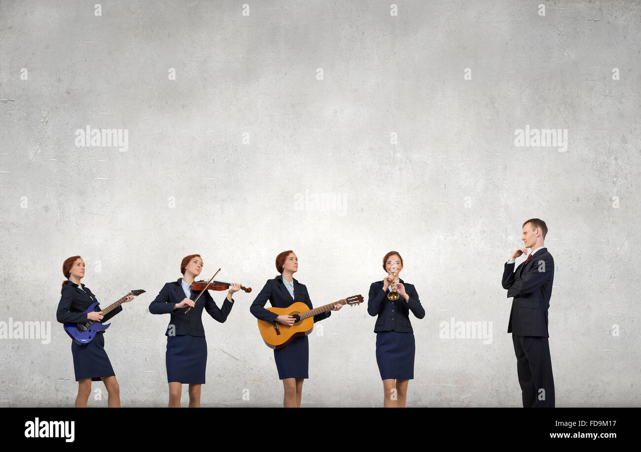 Young woman in suit playing different music instruments Stock Photo - Alamy
