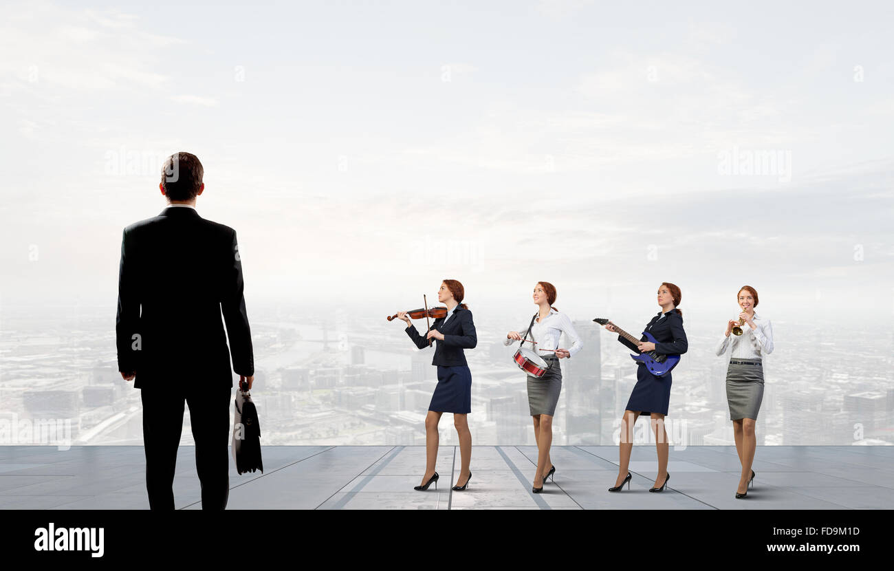 Young woman in suit playing different music instruments Stock Photo - Alamy