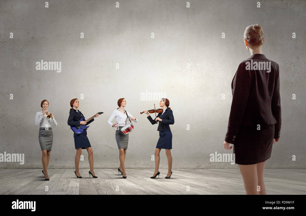 Young woman in suit playing different music instruments Stock Photo - Alamy