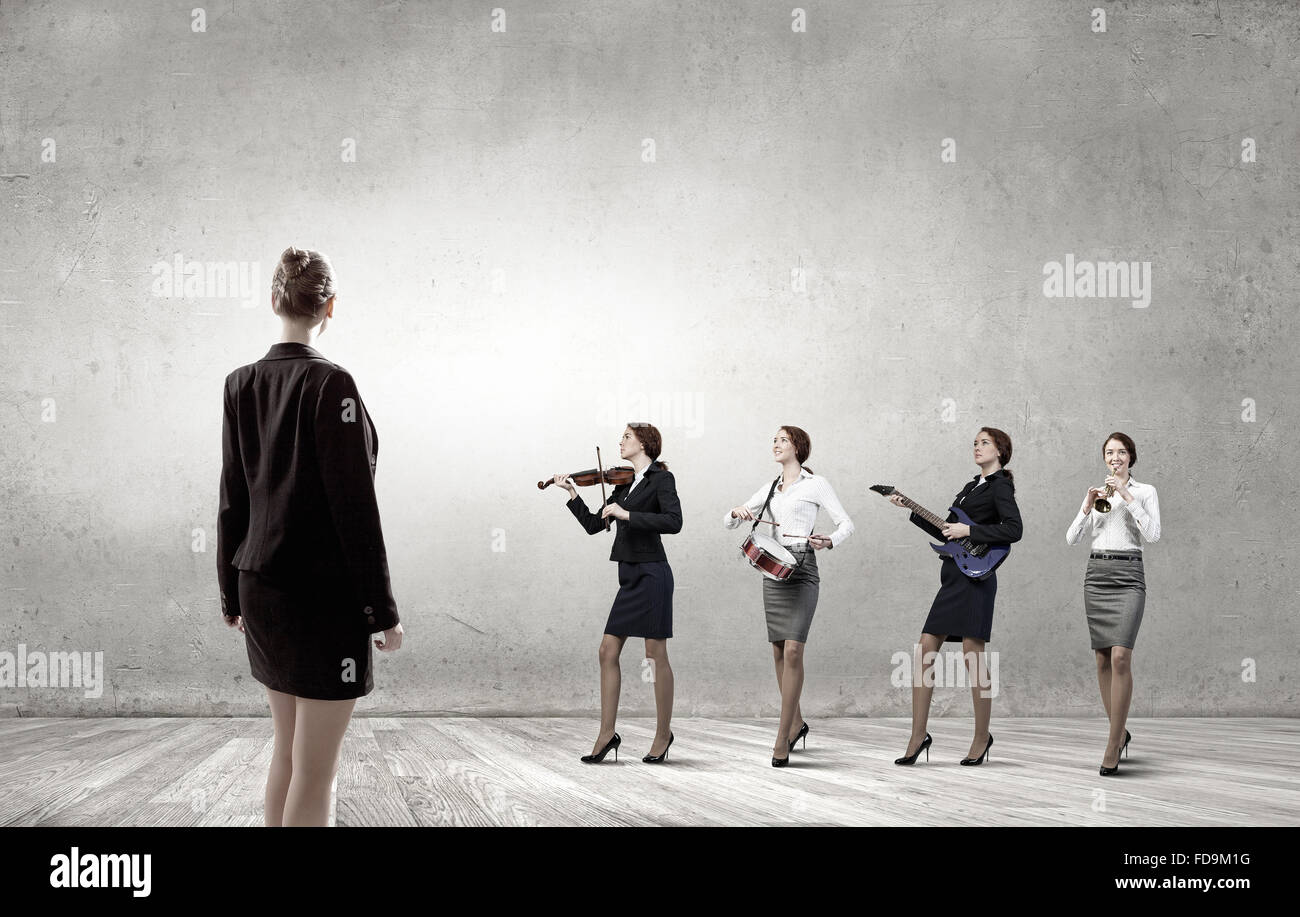 Young woman in suit playing different music instruments Stock Photo - Alamy