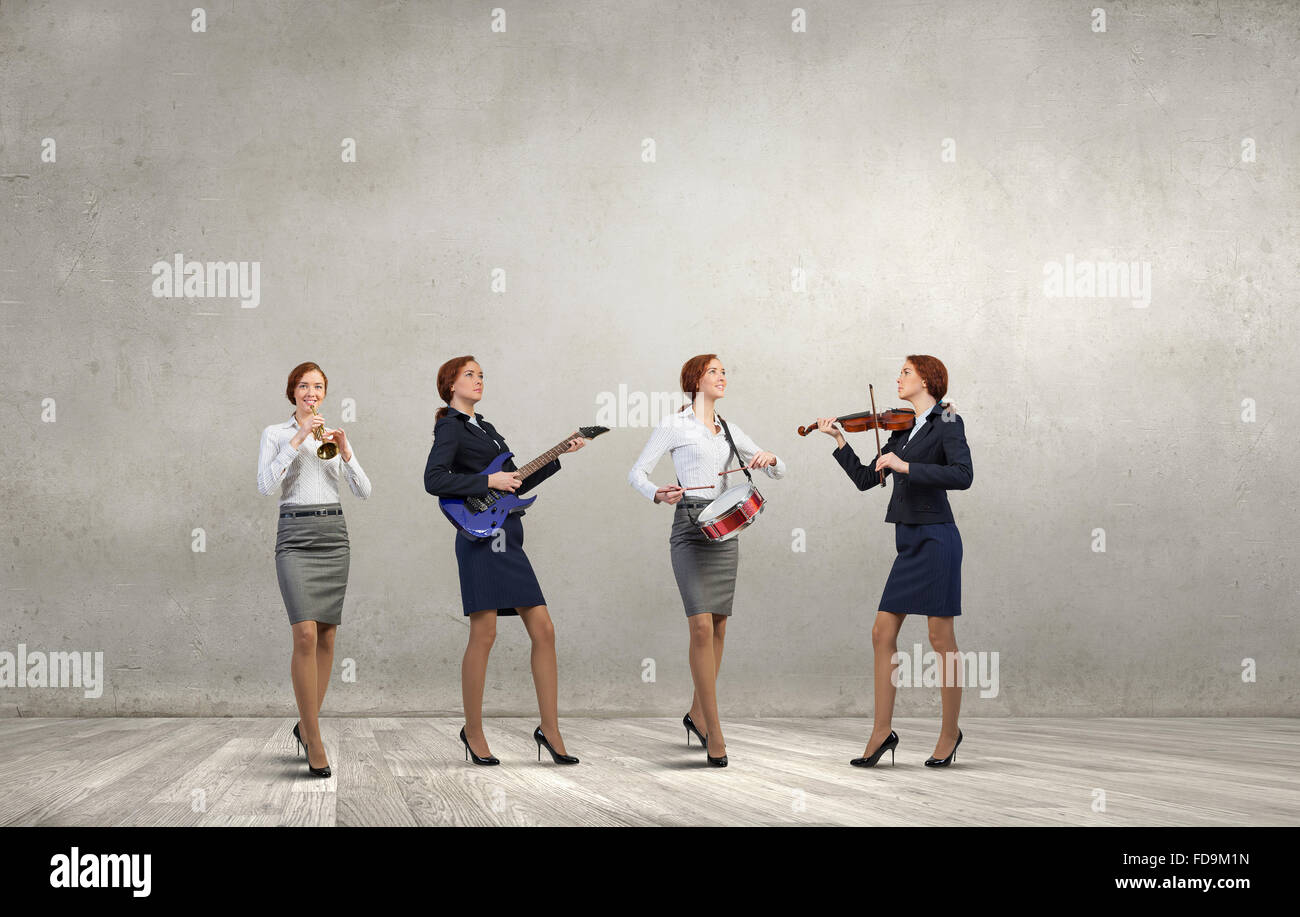 Young woman in suit playing different music instruments Stock Photo - Alamy