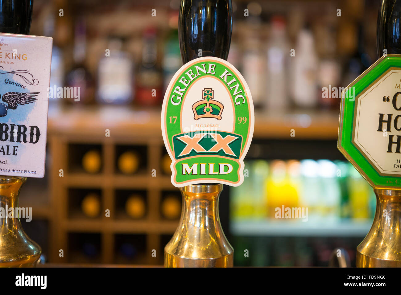 A Greene King Mild beer handpump in the interior of a traditional ...